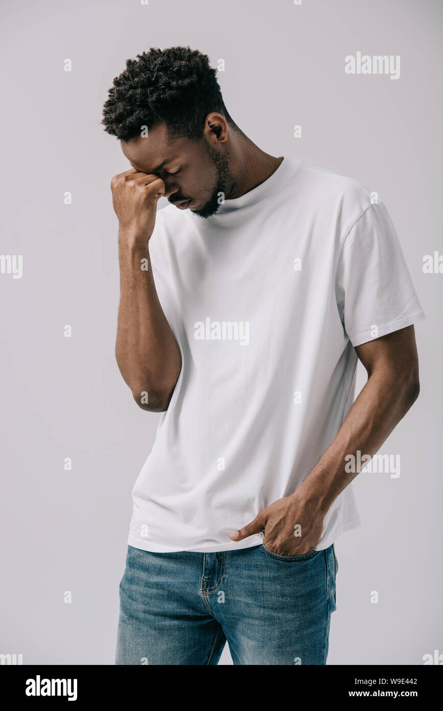 sad african american man touching face isolated on grey Stock Photo - Alamy
