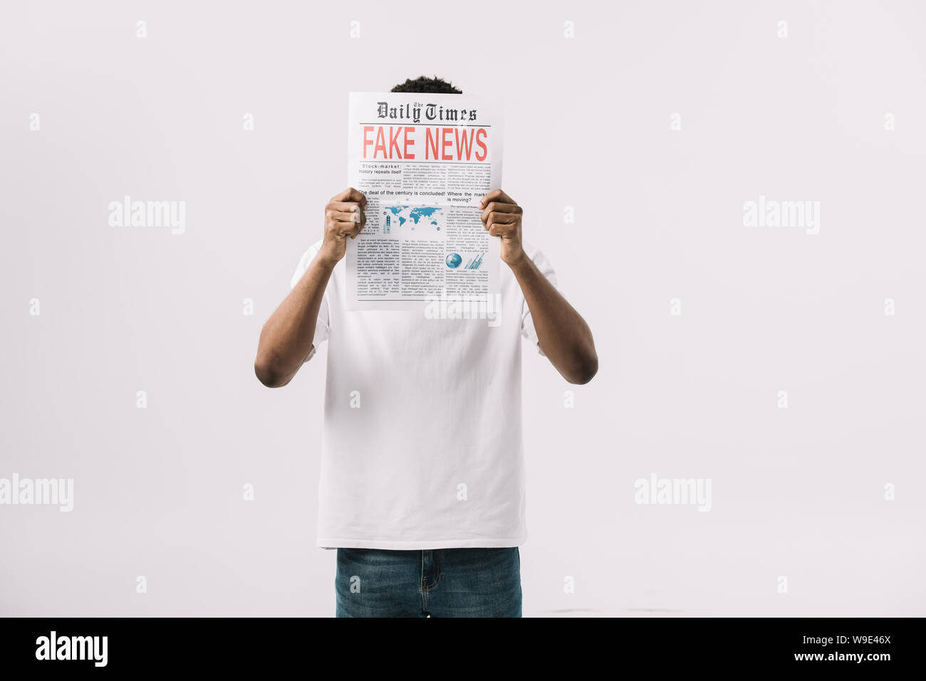 african american man covering face while holding newspaper with fake ...