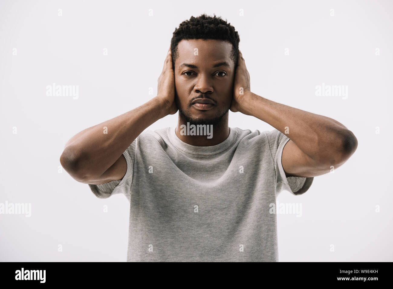 african american man covering ears isolated on white Stock Photo - Alamy