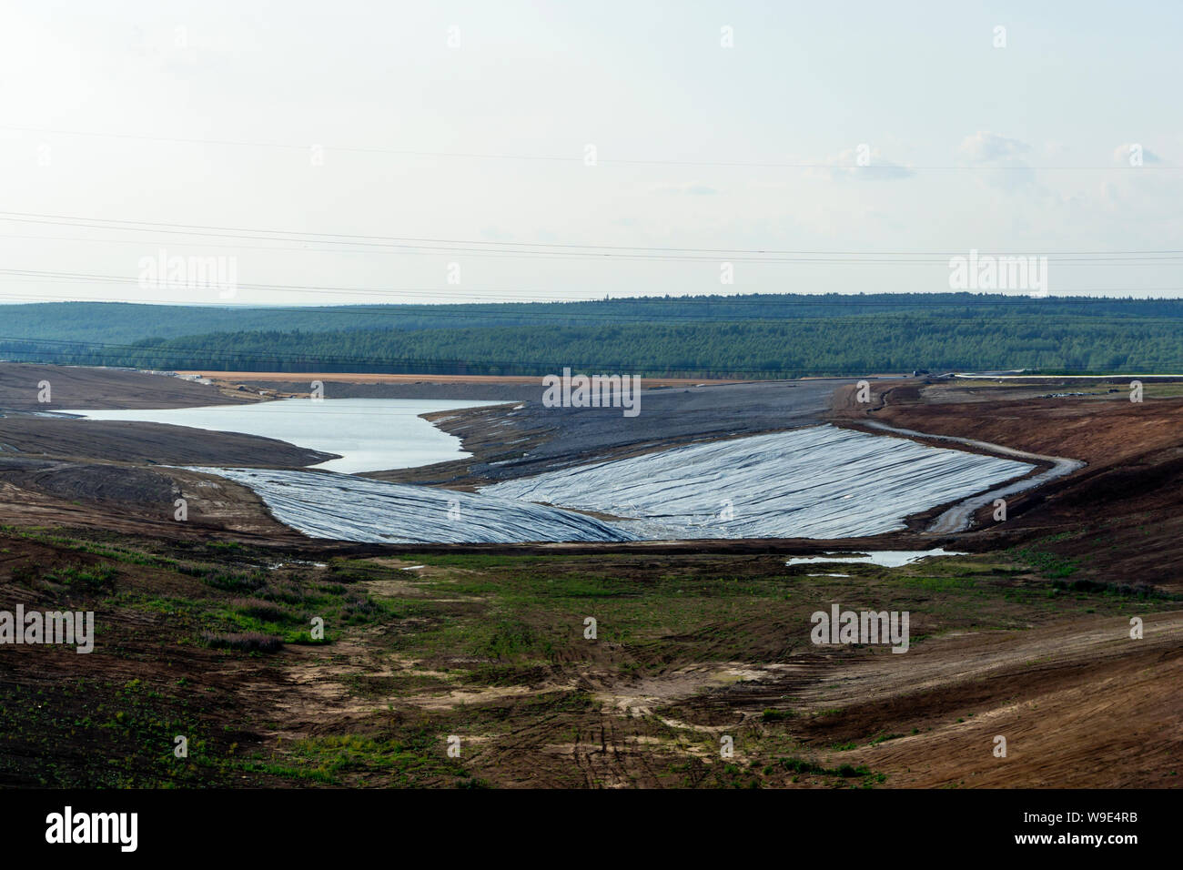 view of the industrial tailing pond under construction in the landscape ...