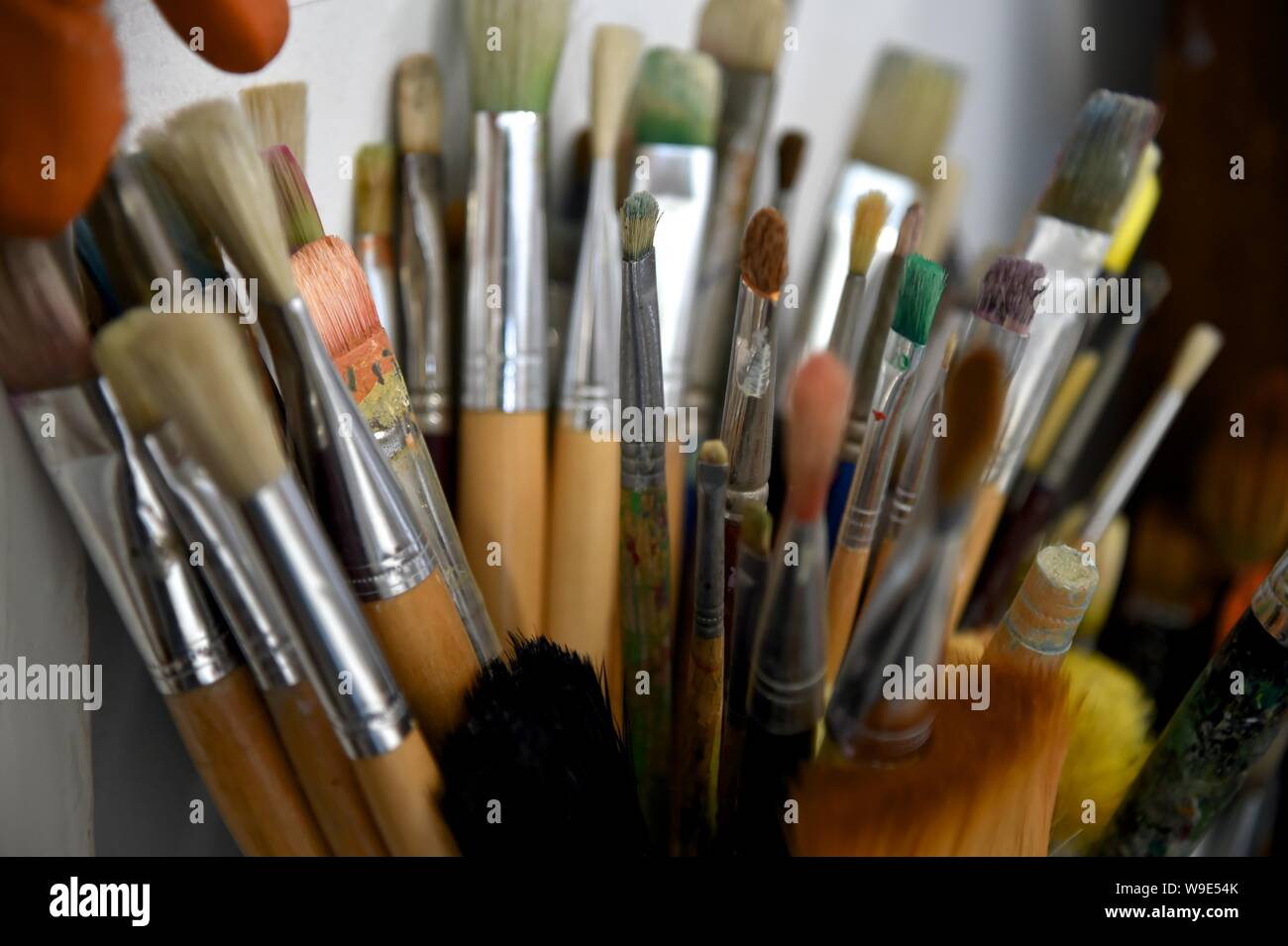Used Artists paint brushes in home studio Stock Photo - Alamy