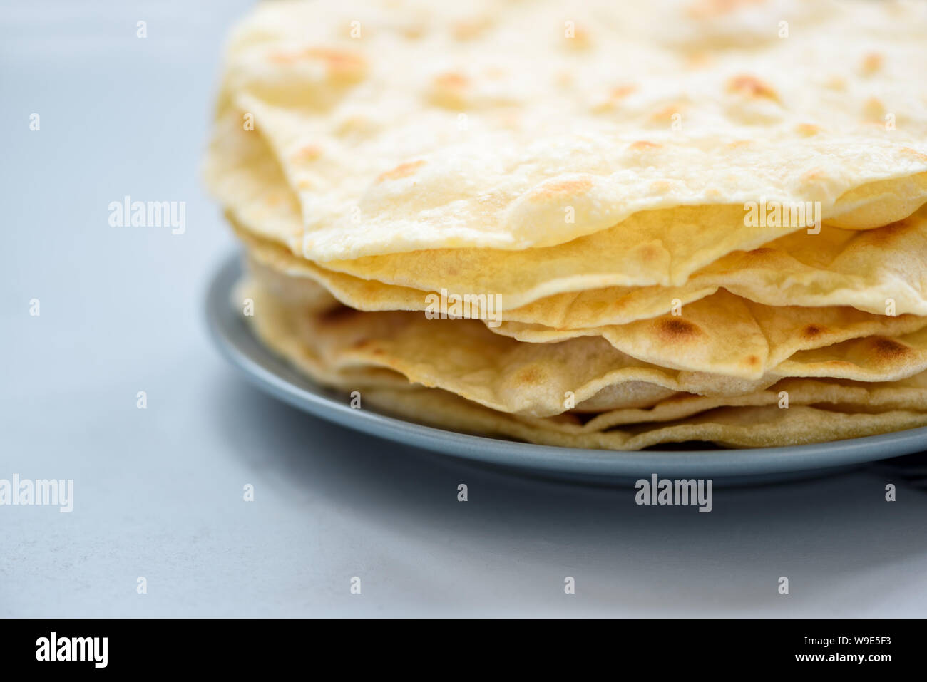 Close up stack of pita, Arabic bread, flatbread on gray wooden ...