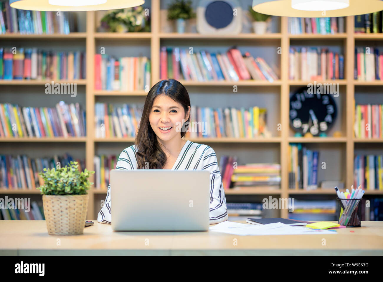 Young asian business freelancer working on the smart computer at Co ...