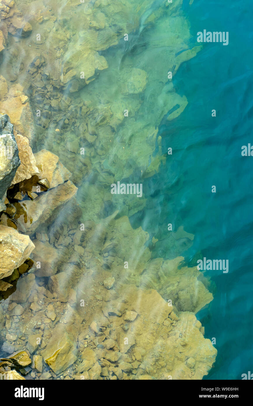 background - transparent greenish water with sunlight reflecting on the ...