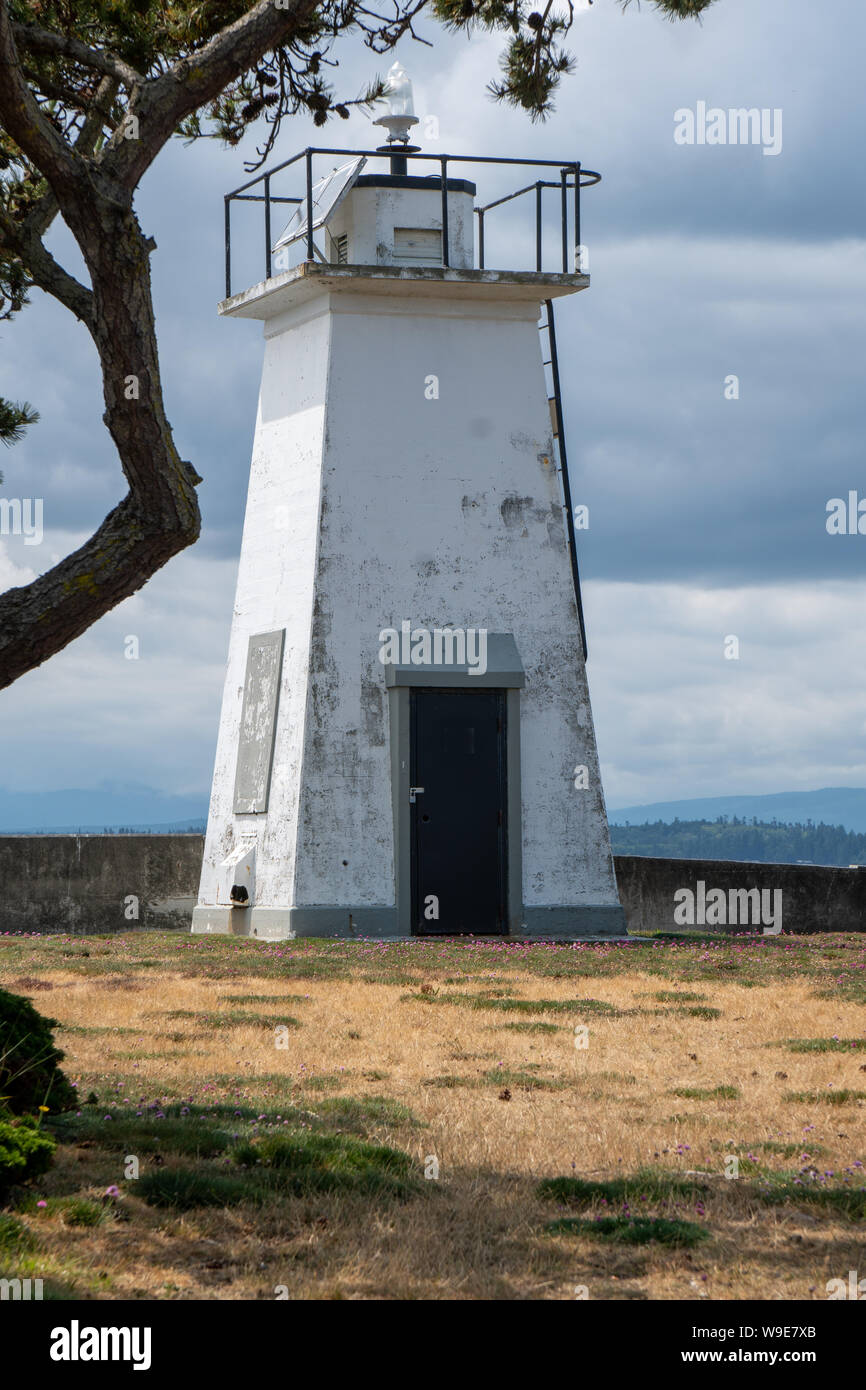 Bush Point Lighthouse, with trees framing the nautical structure on a ...
