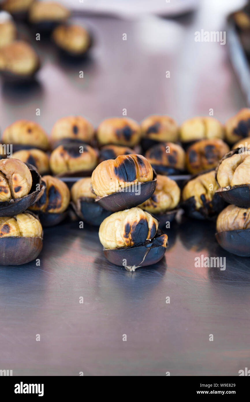 Closeup view at the fresh roasted chesnuts Stock Photo - Alamy