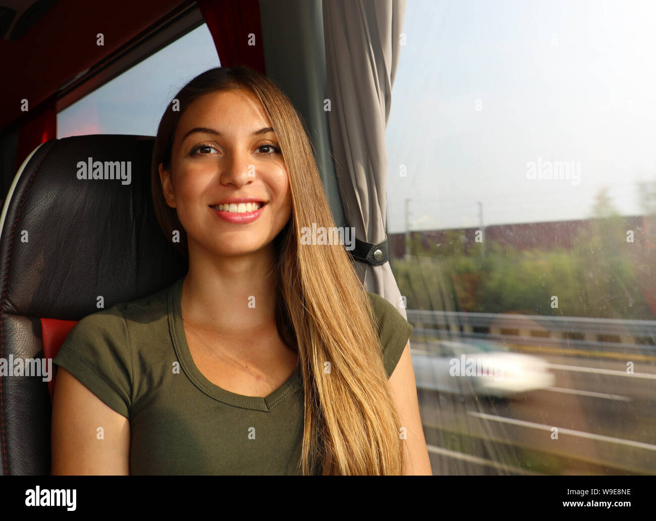 Smiling beautiful traveler woman on bus looking at camera. Concept ...
