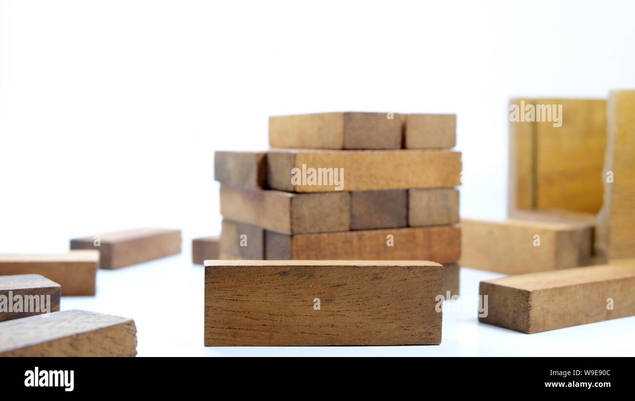Empty wooden bricks in front of the construction of the tower Jenga ...