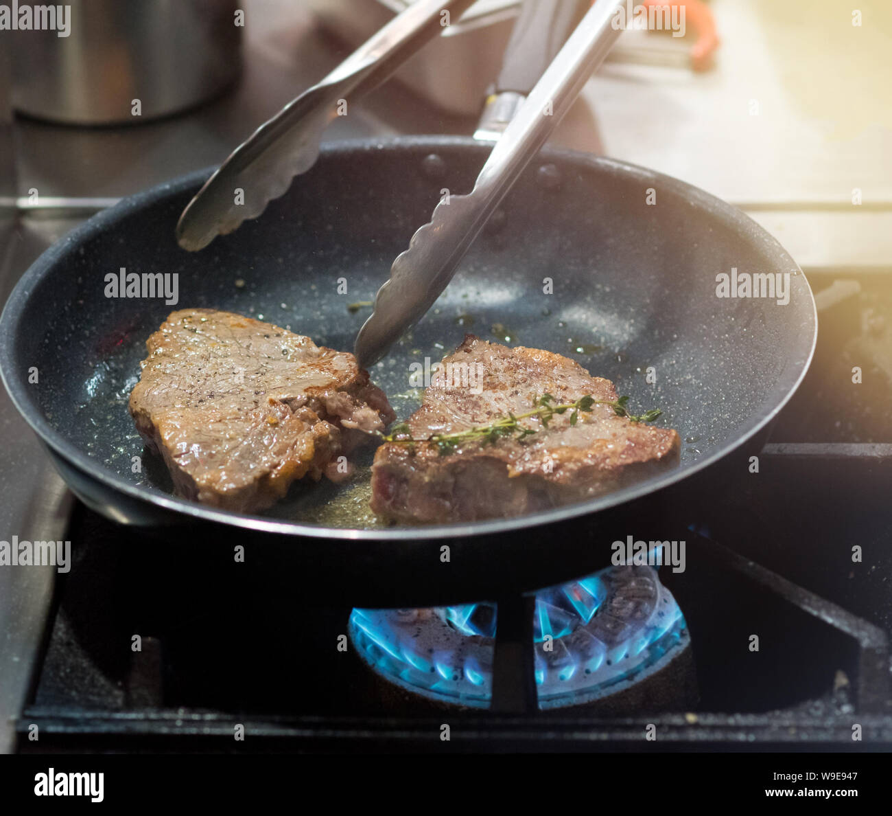 Frying Steak on Pan, Steak in the pan in the Kitchen Stock Photo - Alamy