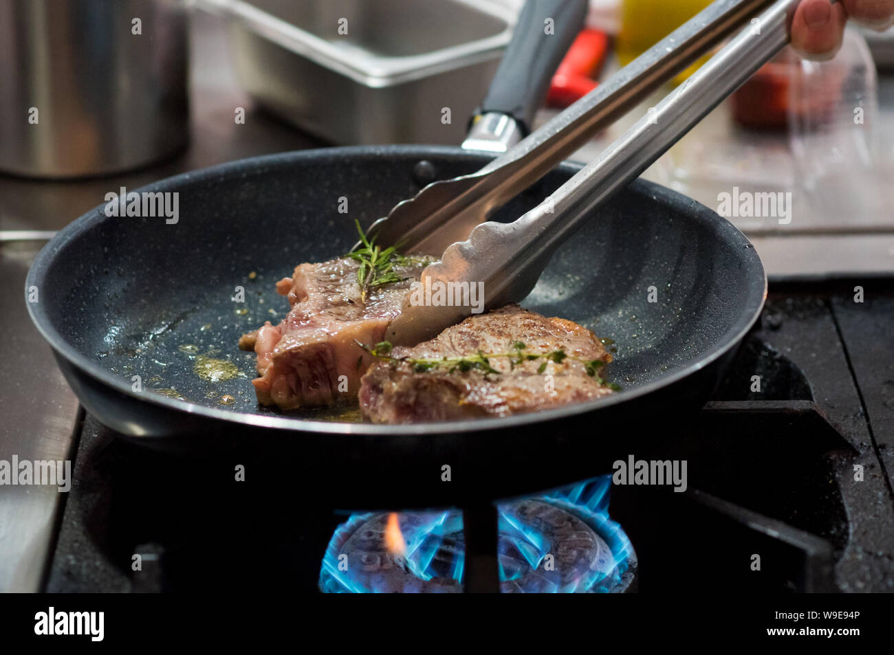 Frying Steak on Pan, Steak in the pan in the Kitchen Stock Photo - Alamy