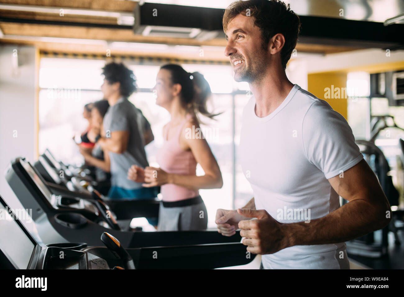 Fit people running in machine treadmill at fitness gym Stock Photo - Alamy