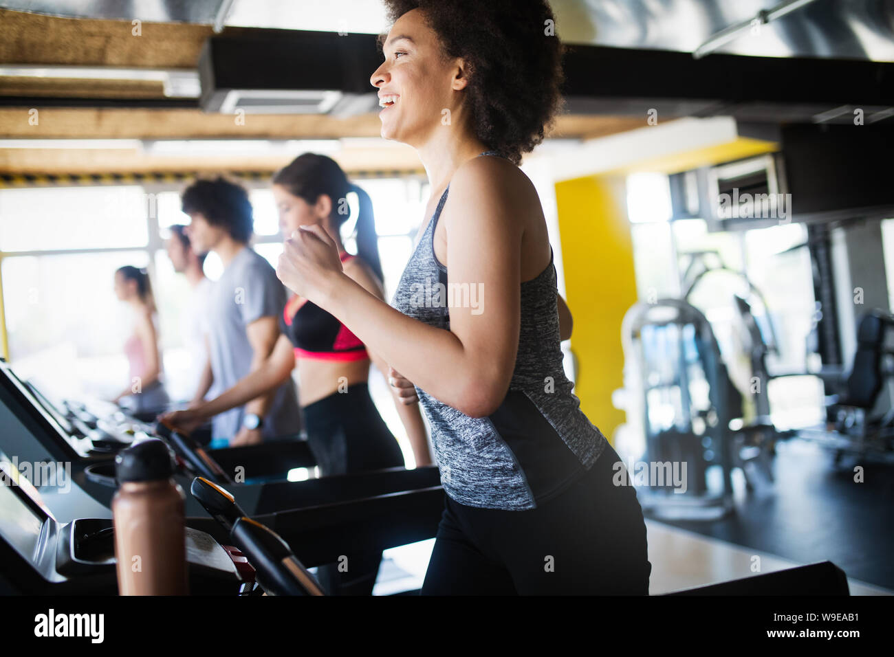 Beautiful fit people exercising together in gym Stock Photo - Alamy