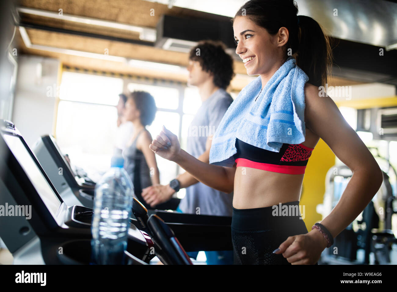 Beautiful fit people exercising together in gym Stock Photo - Alamy