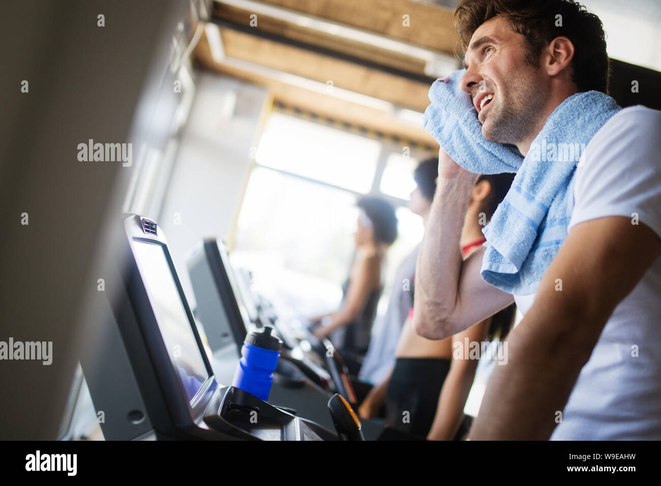 Sweaty after great work out. Handsome young men in sportswear whipping ...