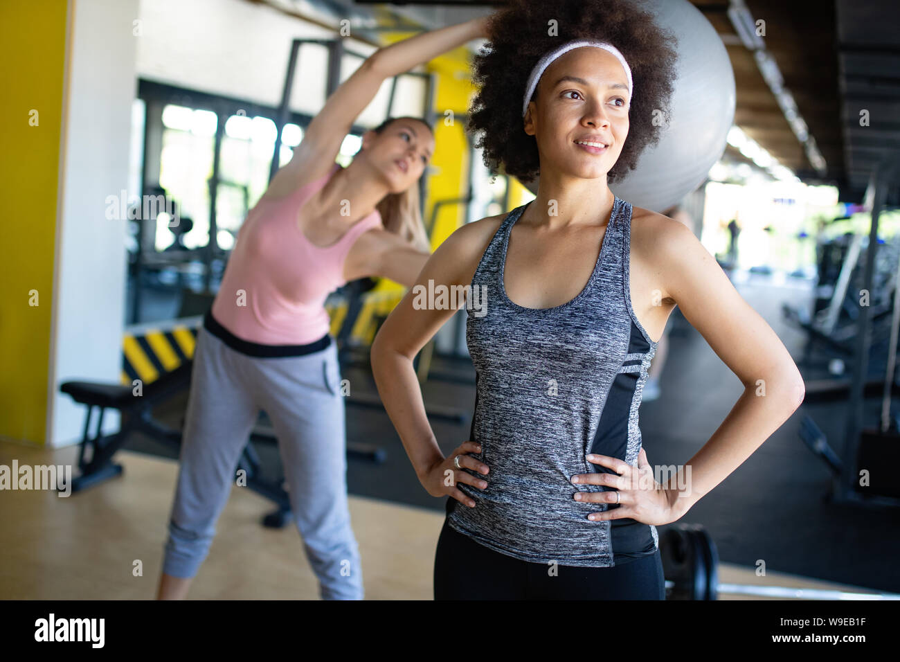 Beautiful fit women exercising together in gym Stock Photo - Alamy