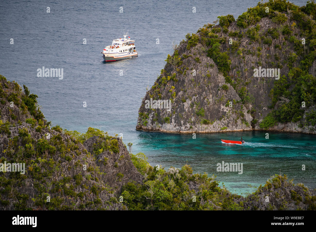 small boat heading out to sea at the archipelago of Raja Amapat Stock ...