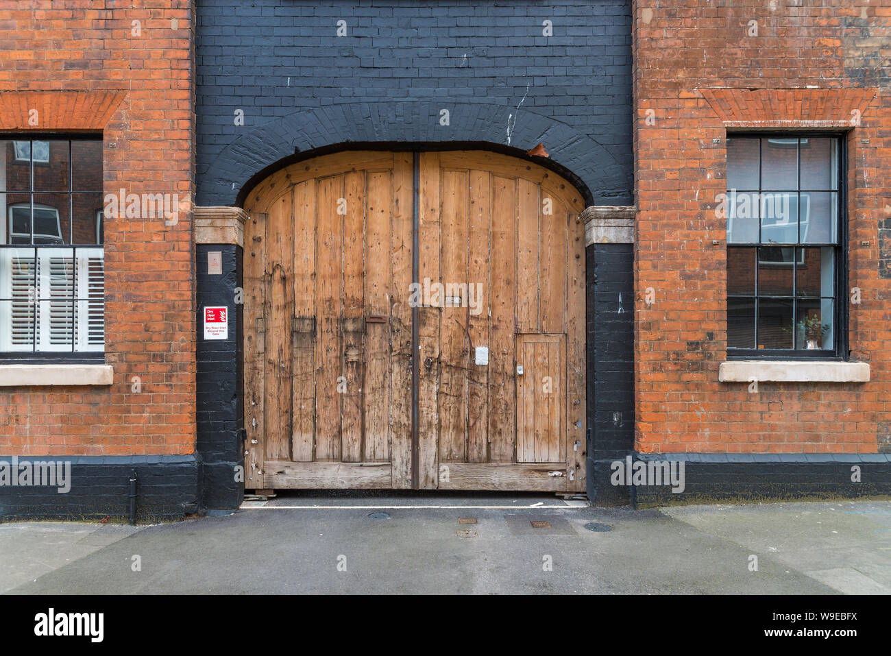 Large wooden double doors at entrance to old factory which now contains ...