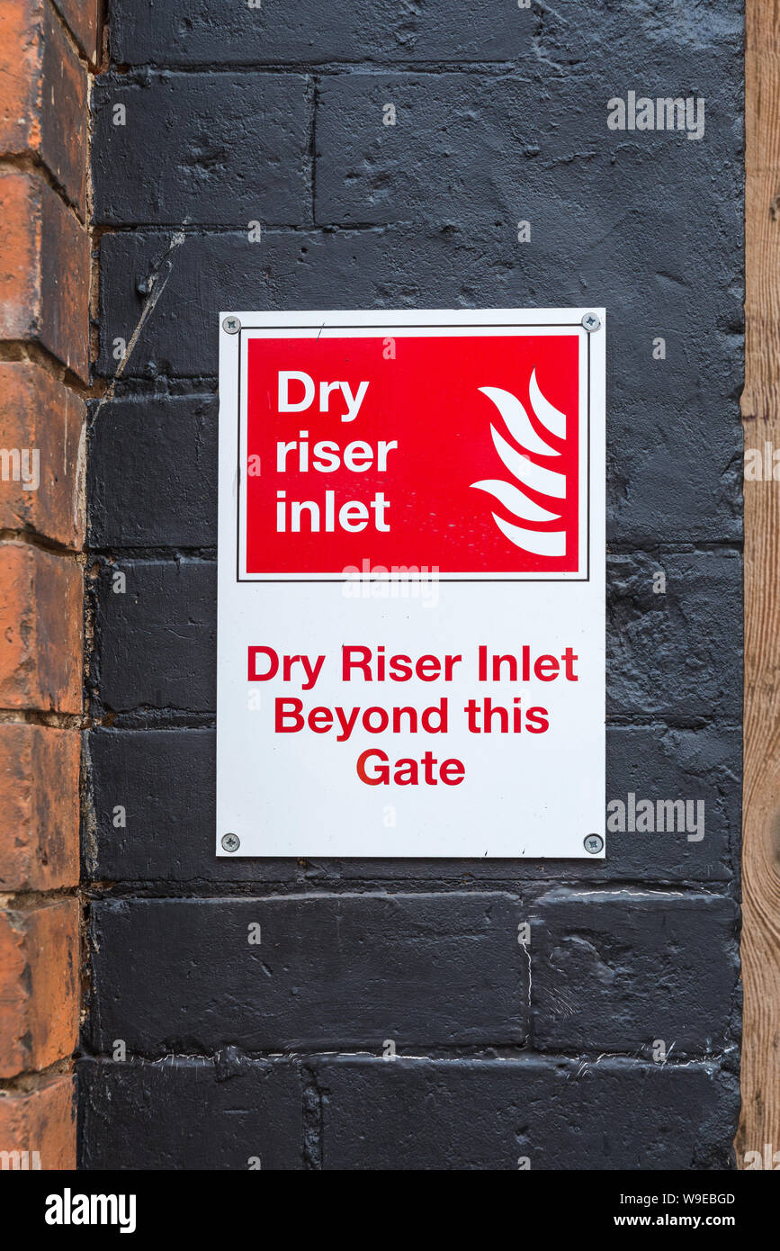 Sign marking location of dry riser inlet for firemen in event of a fire ...