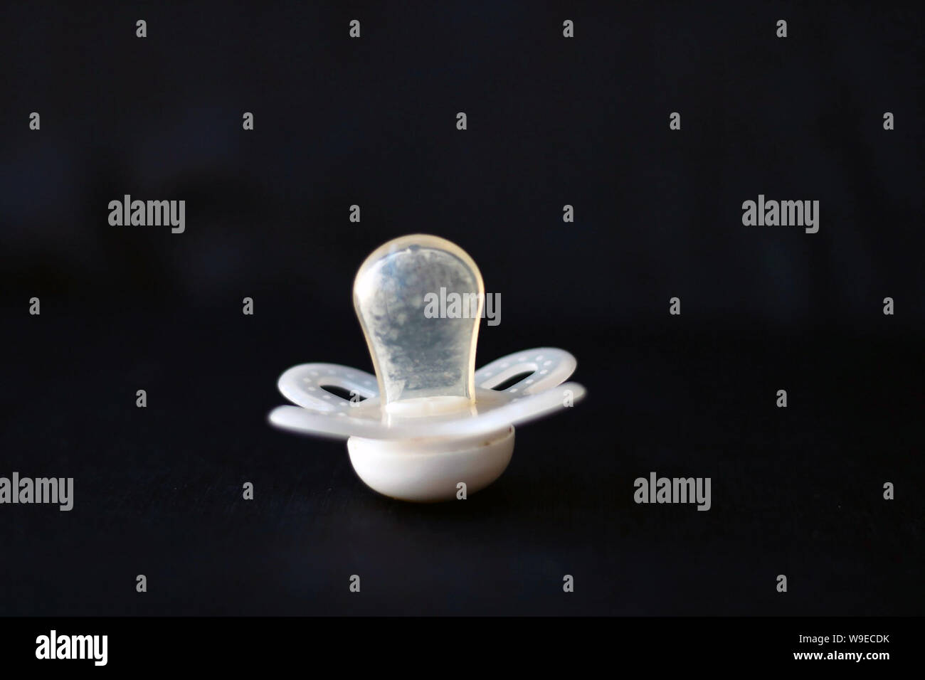 White pacifier on a white background Stock Photo - Alamy
