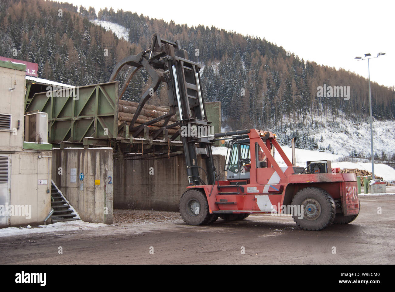Wheel loader working at timber yard of a large sawmill, where the wood ...