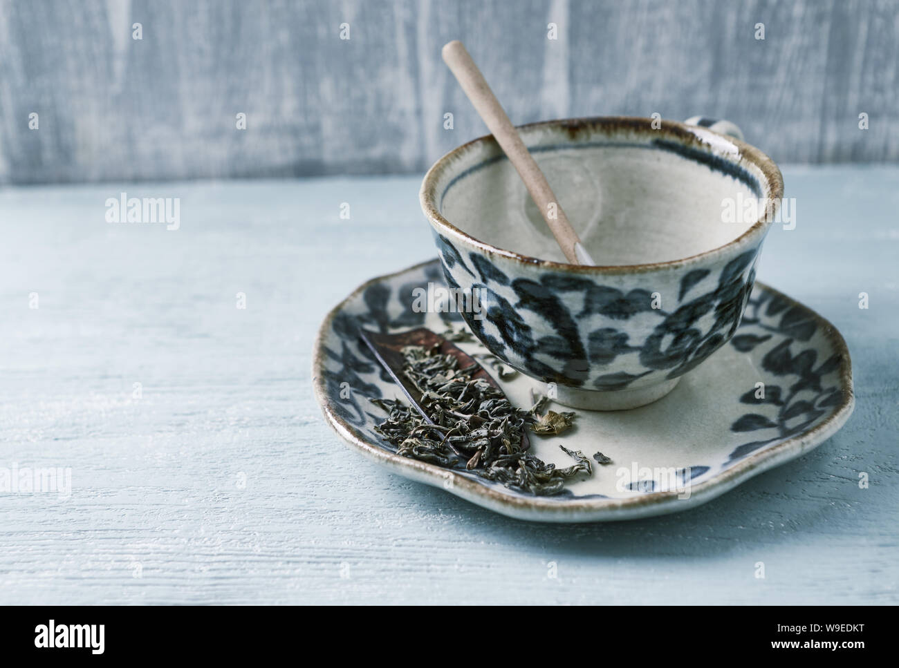 Empty Ceramic Tea Cup and Green Tea Leaves. Symbolic image. Asian ...
