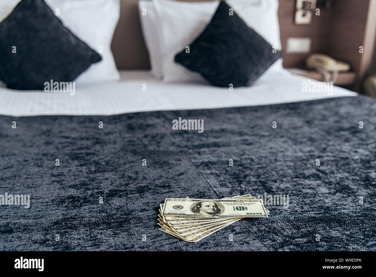 dollar banknotes on bed with pillows in hotel room Stock Photo - Alamy