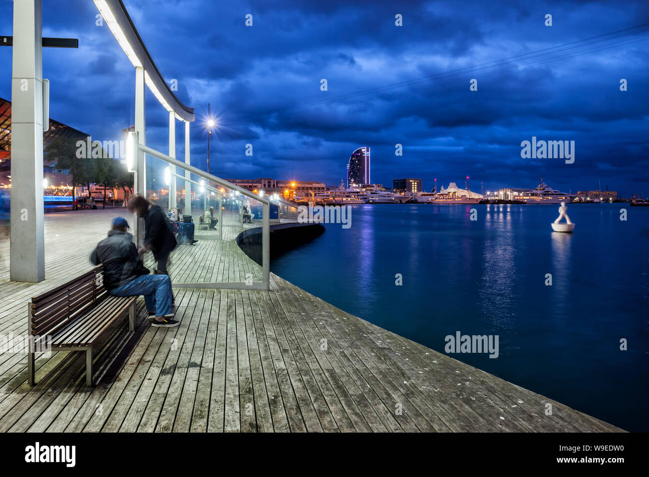 Rambla de Mar seaside boardwalk promenade at Port Vell by night in city ...