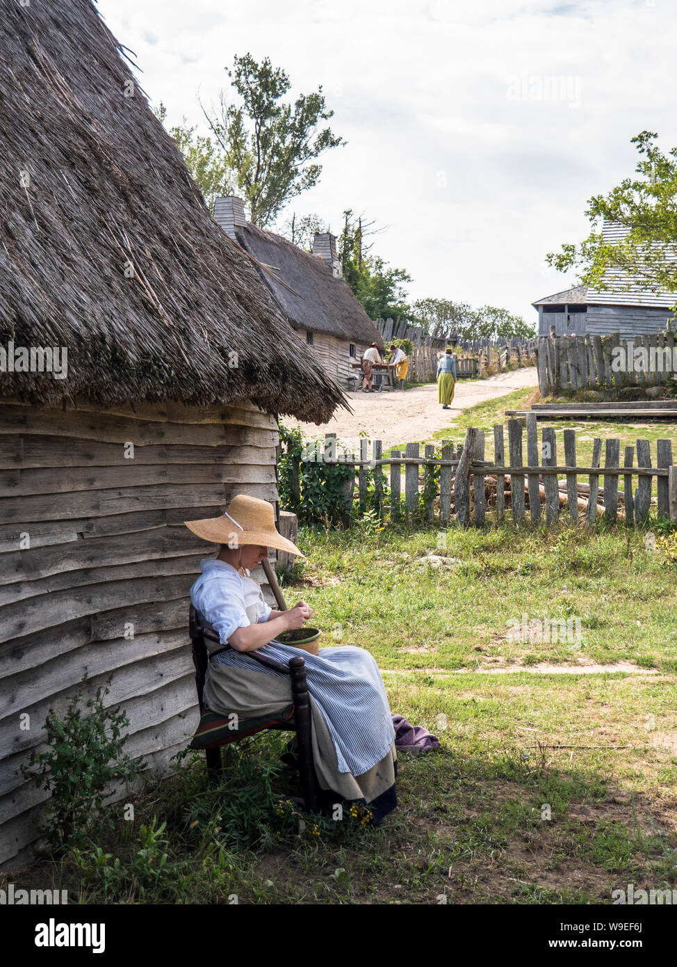 Pilgrim woman near here home with other pilgrims in the background ...