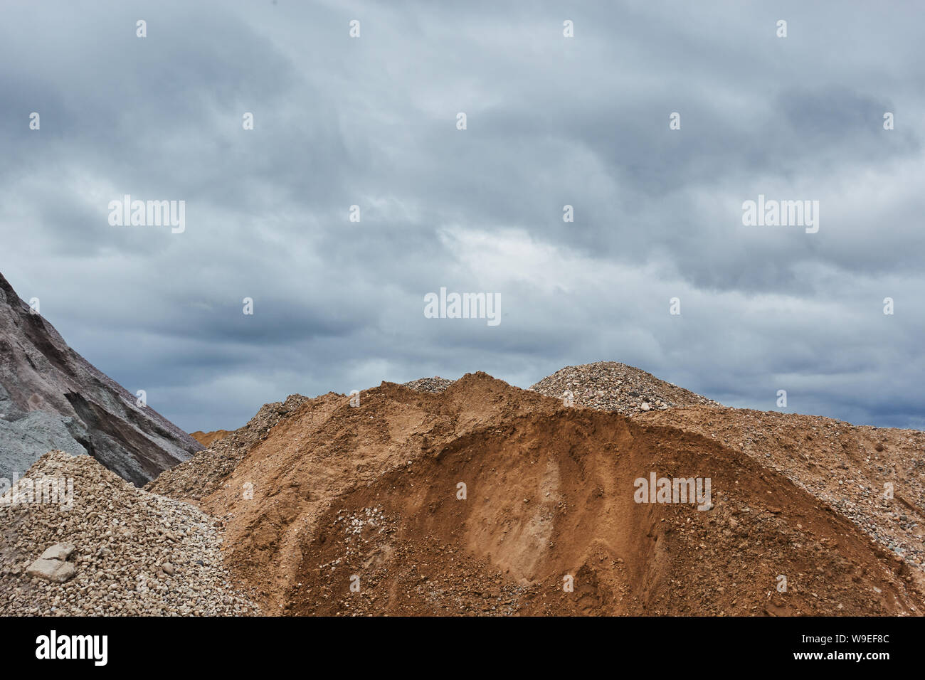 Industrial quarry with mountains of sand and rubble Stock Photo - Alamy