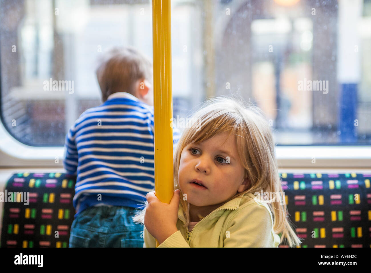 Two small children riding the London underground Stock Photo - Alamy