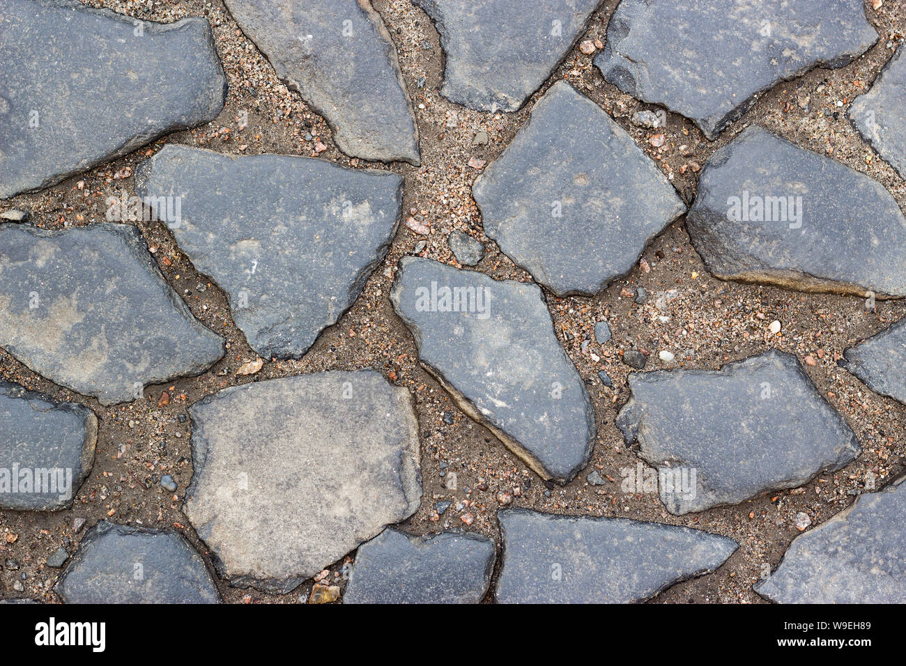 Ancient street pavement made of levelled stones into the ground Stock ...