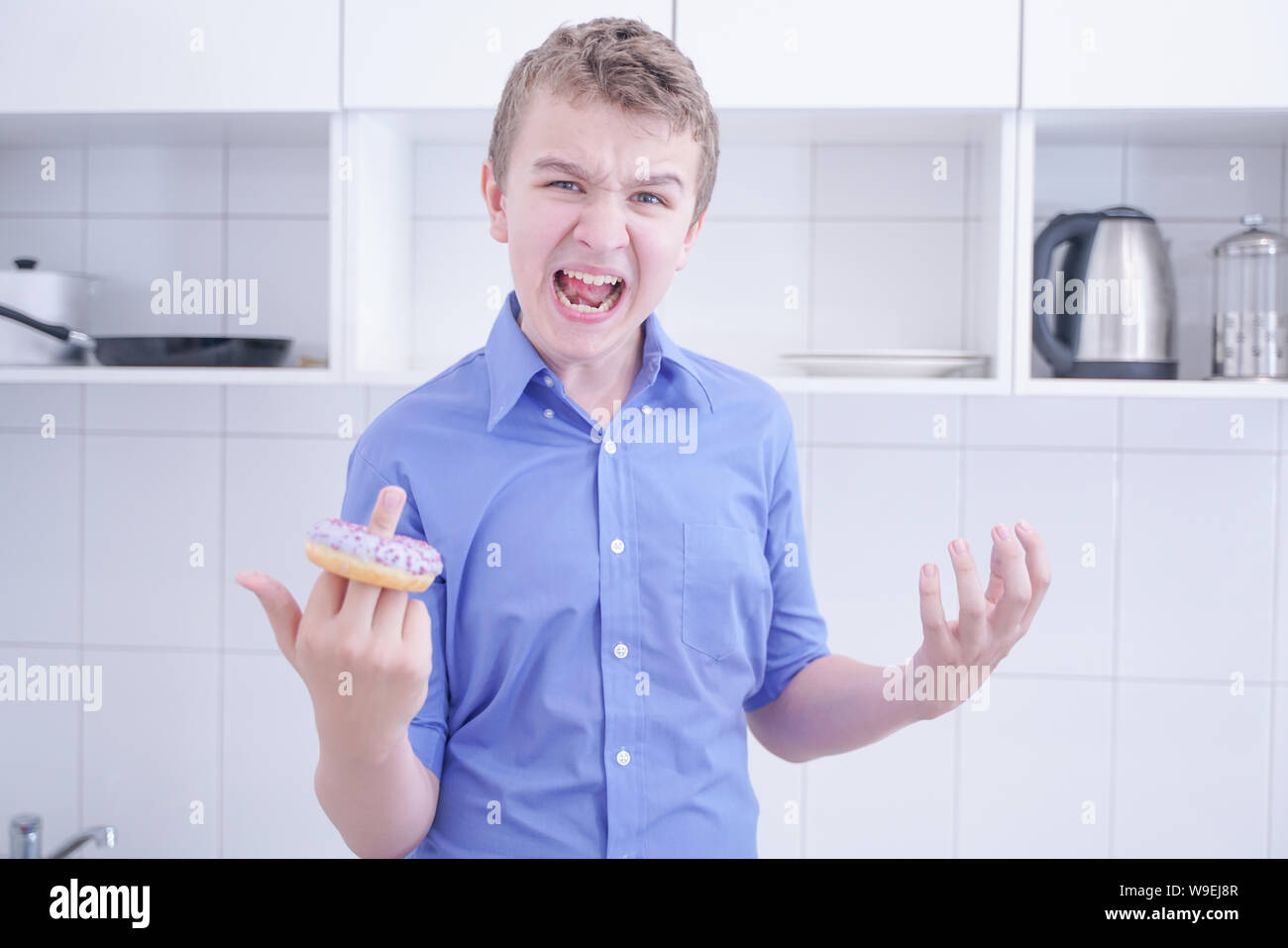 preteen handsome boy refuse to eat unhealthy food Stock Photo - Alamy