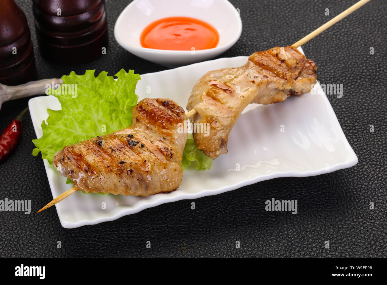 Chicken wings skewer with spicy sauce Stock Photo - Alamy