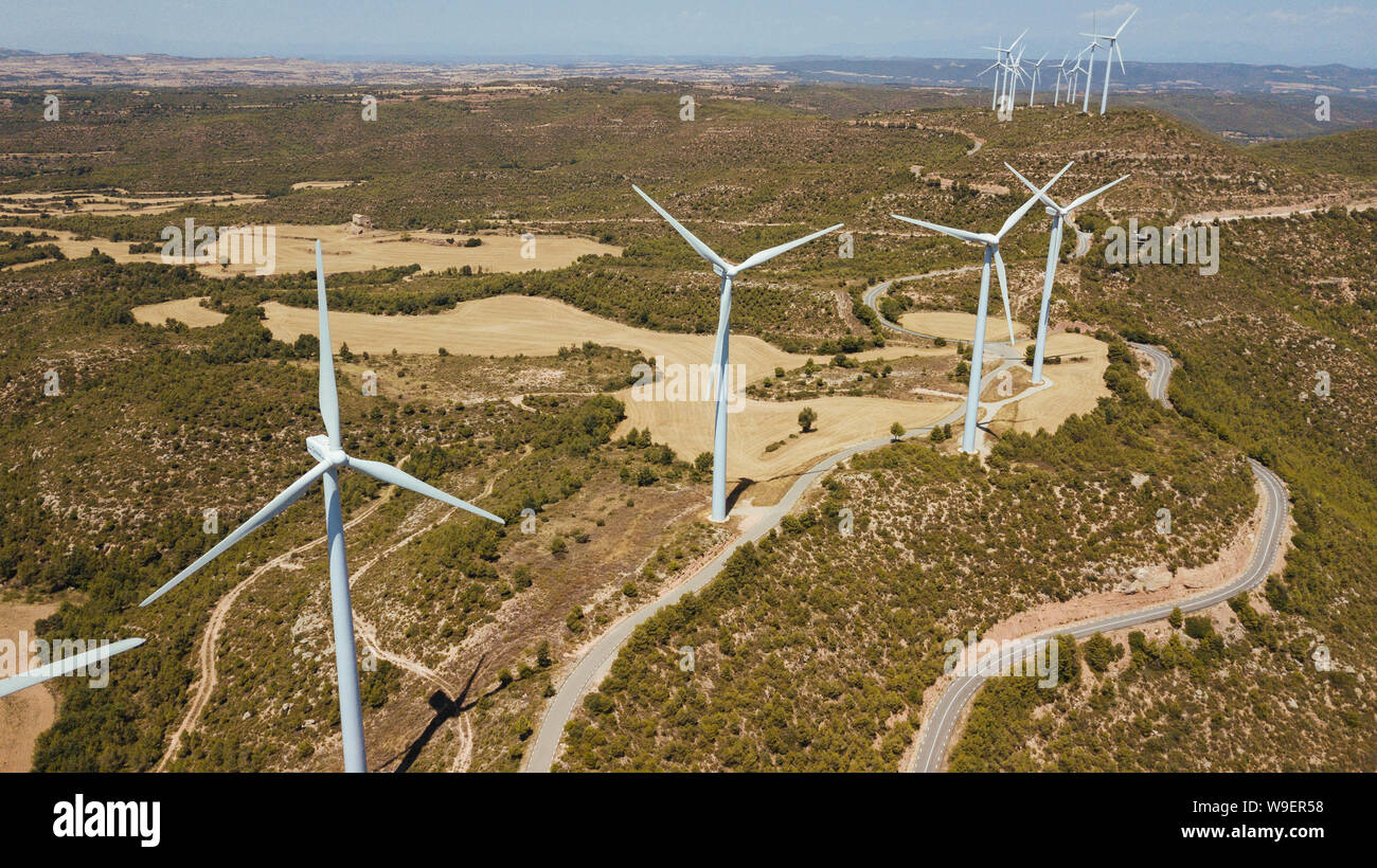 Wind turbine on green fields in summertime. Natural wind power plants ...