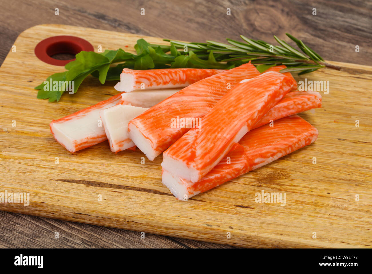 Crab stick surimi over wooden board Stock Photo - Alamy
