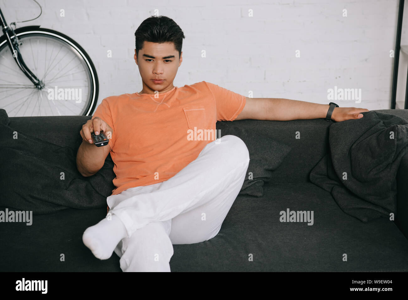 Man holding tv remote hi-res stock photography and images - Alamy