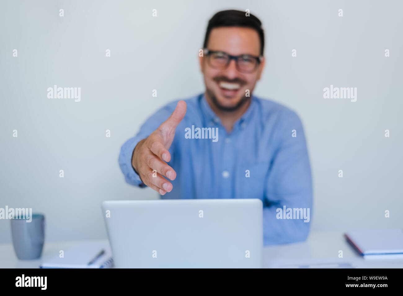 Handsome cheerful smiling young businessman entrepreneur manager or ...