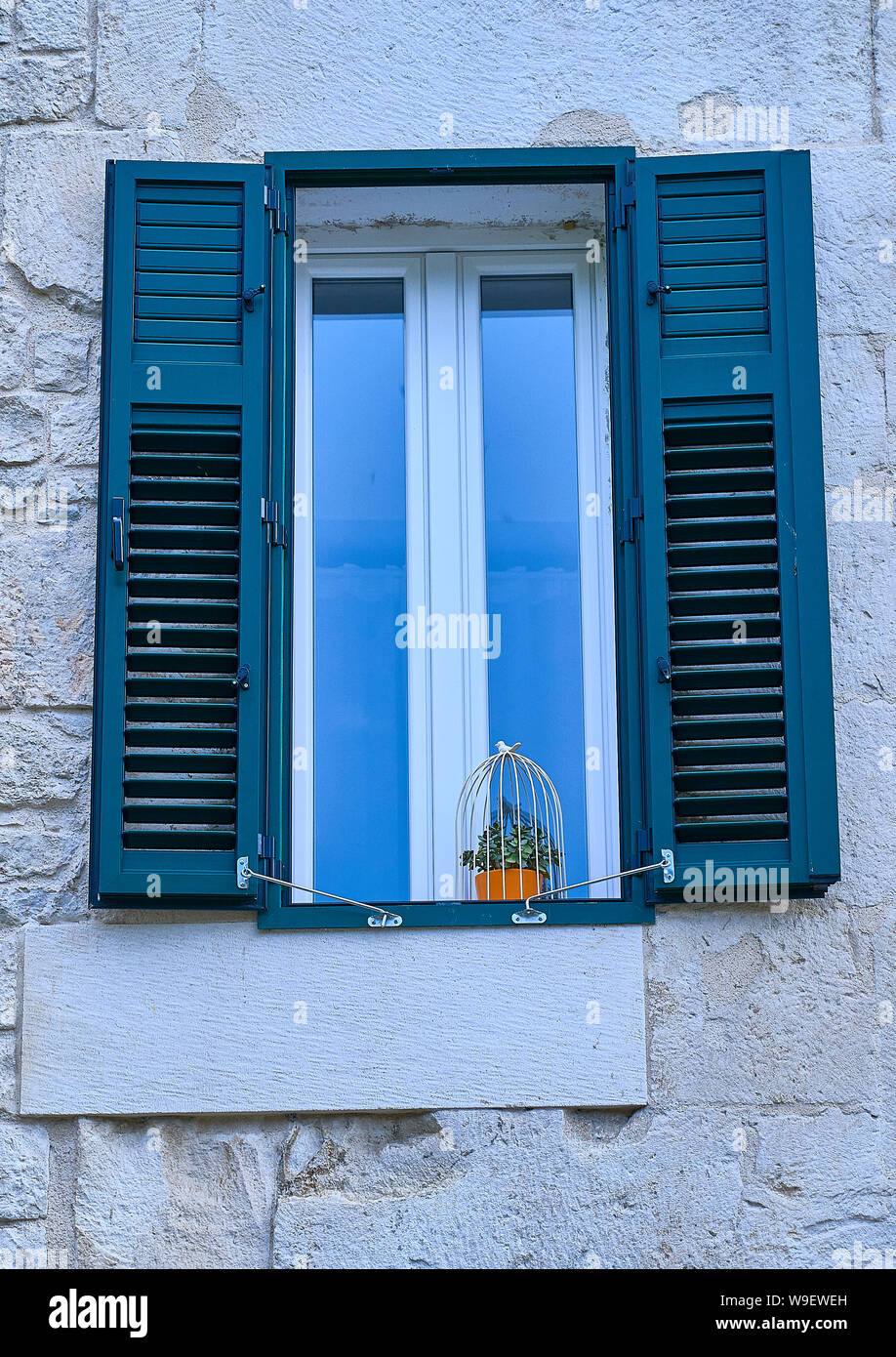 Blue window in a stone wall Stock Photo - Alamy