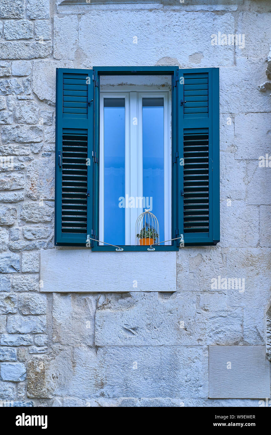 Blue window in a stone wall Stock Photo - Alamy