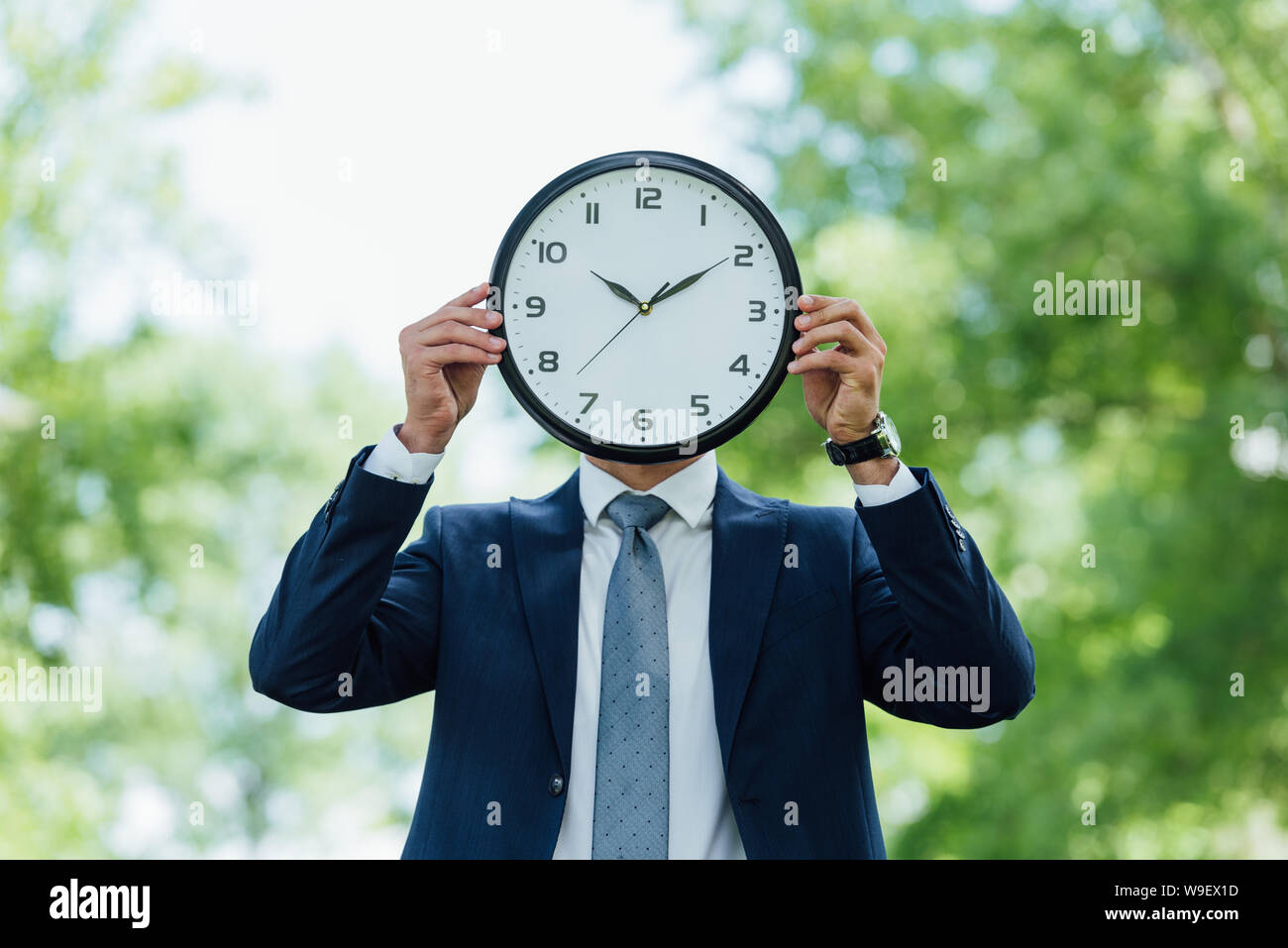 Man in suit clock face hi-res stock photography and images - Alamy