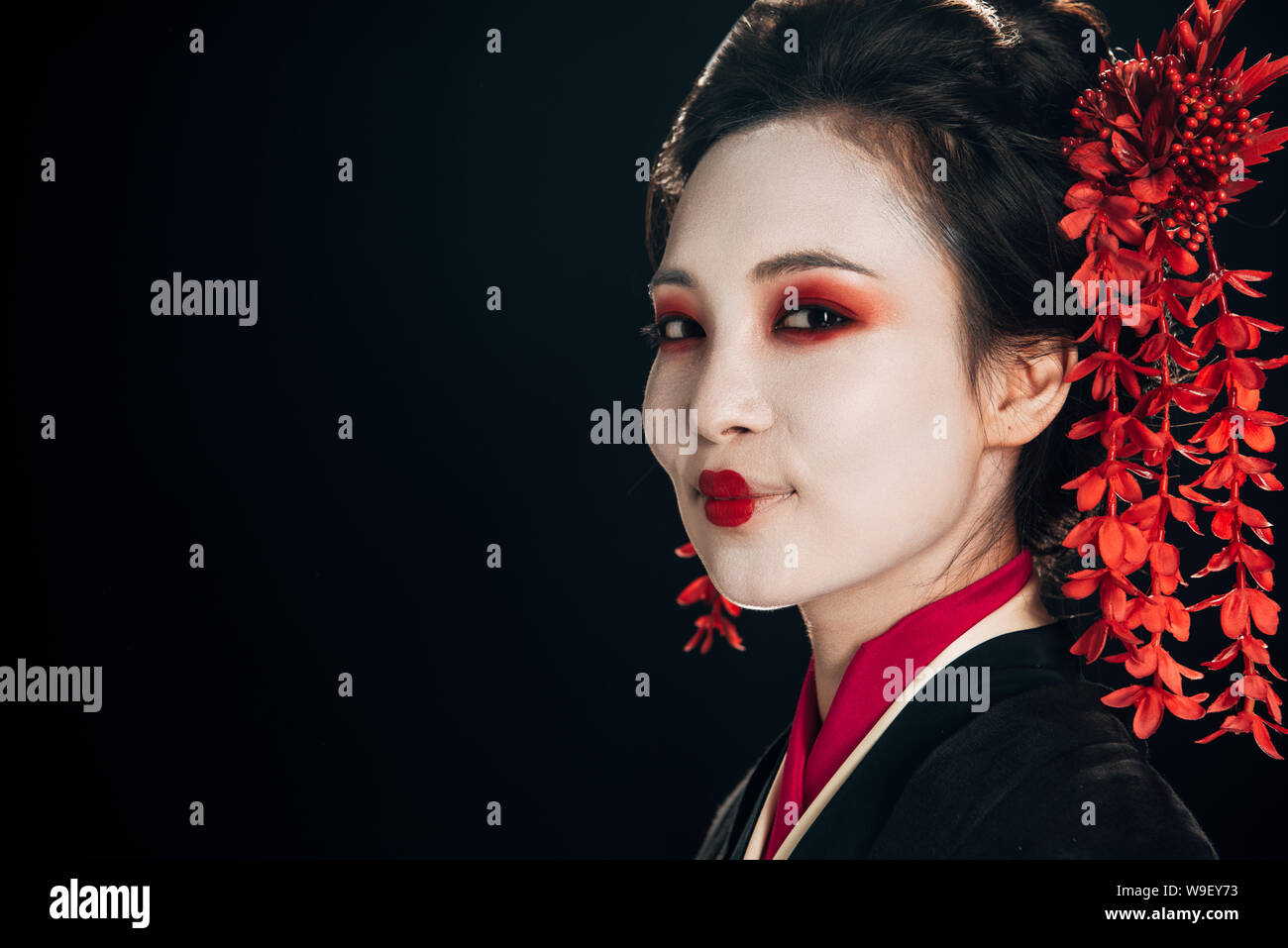 smiling beautiful geisha in black and red kimono and flowers in hair ...