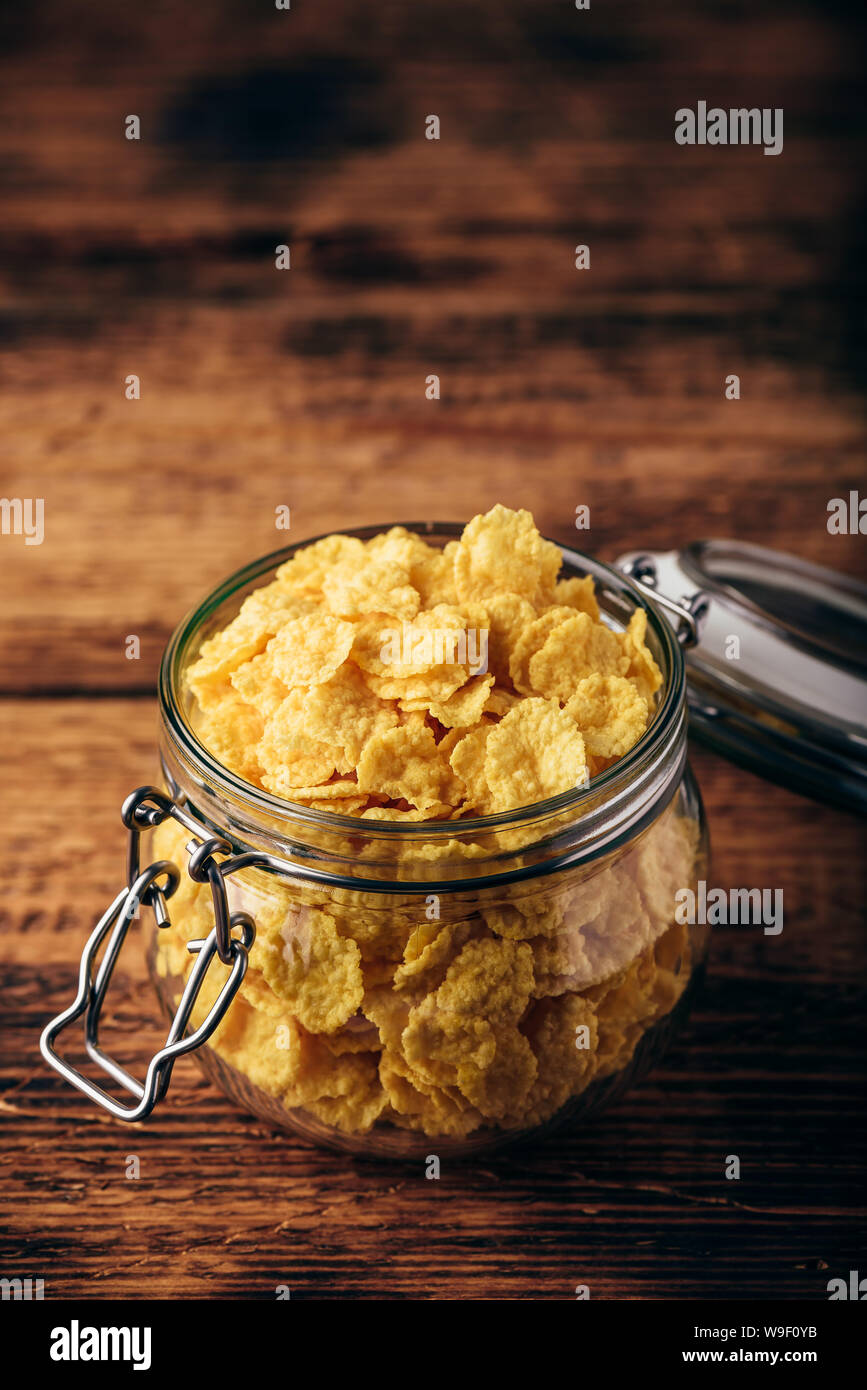 Corn flakes in a glass jar on wooden surface Stock Photo - Alamy