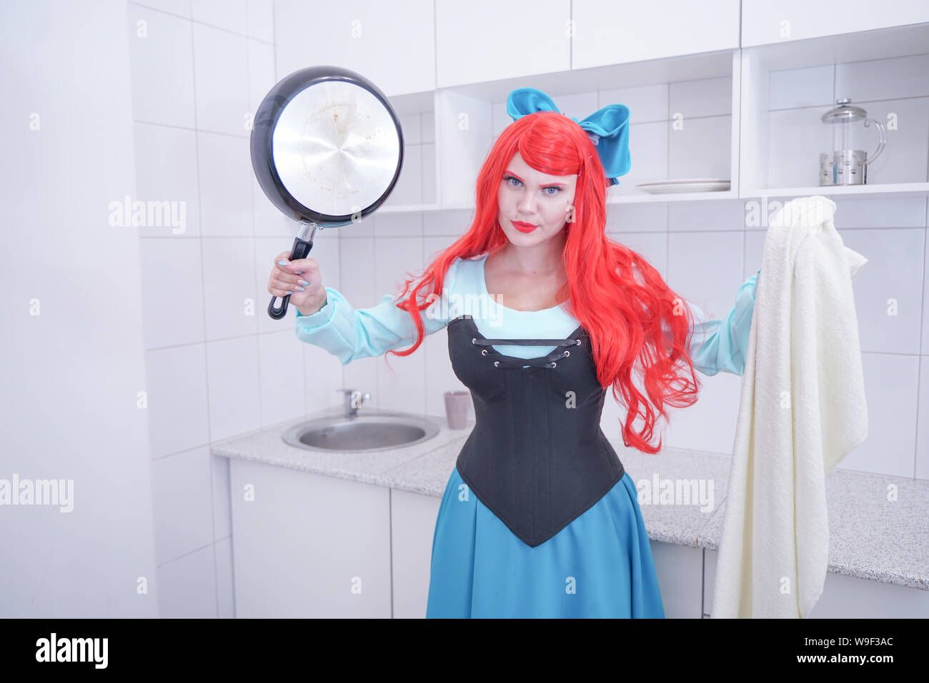 Redhaired plus size angry sad woman holding frying pan Stock Photo - Alamy