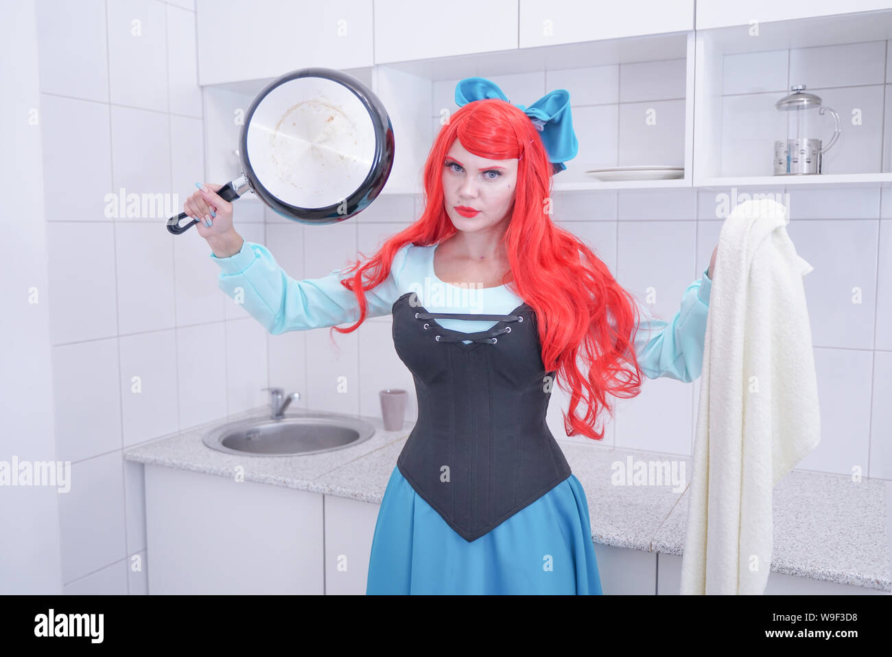Redhaired plus size angry sad woman holding frying pan Stock Photo - Alamy