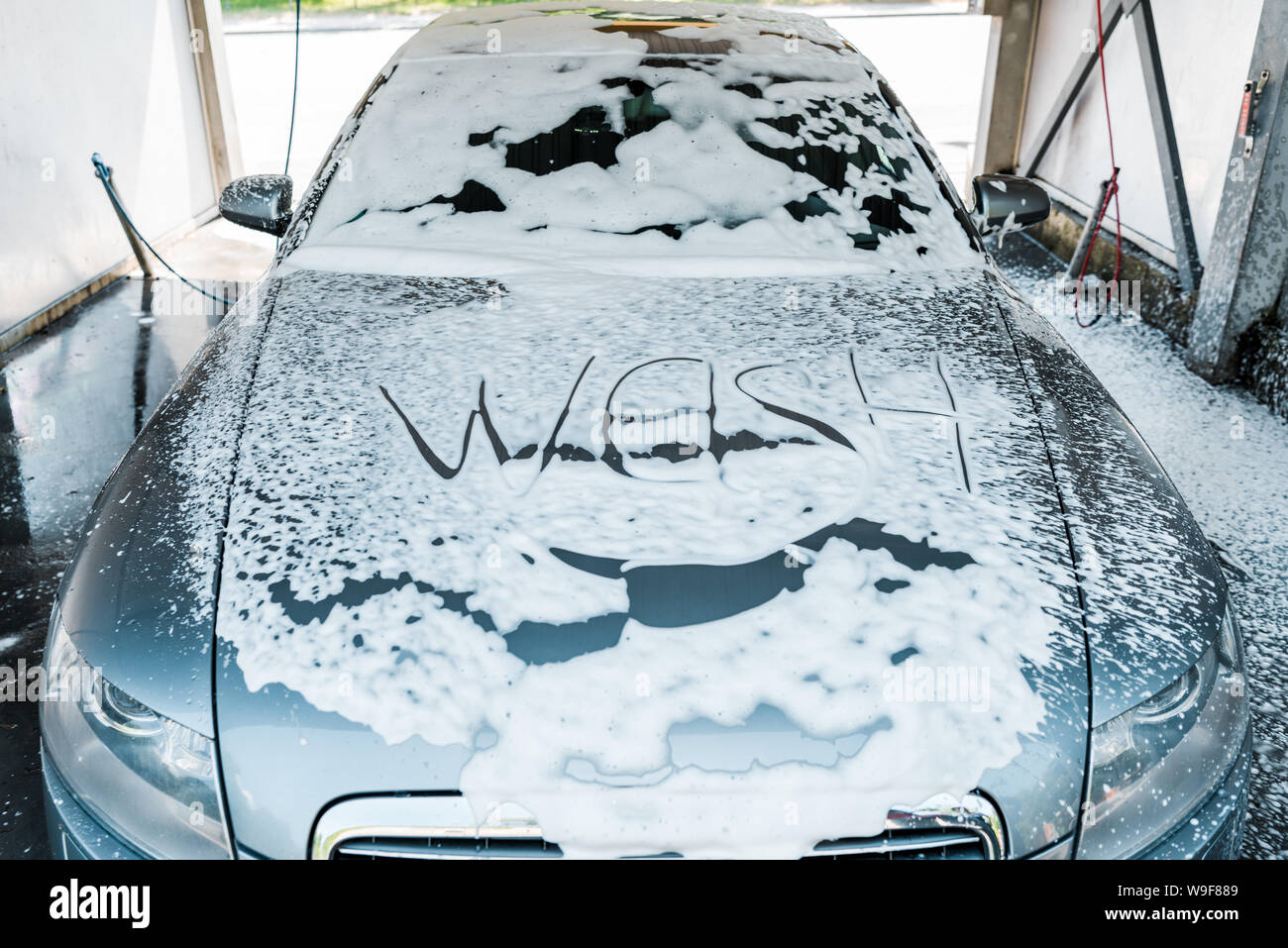 wash lettering on modern car with white foam Stock Photo - Alamy