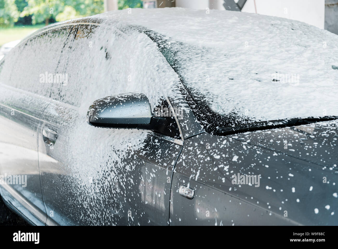 modern grey car with white foam in car wash Stock Photo - Alamy