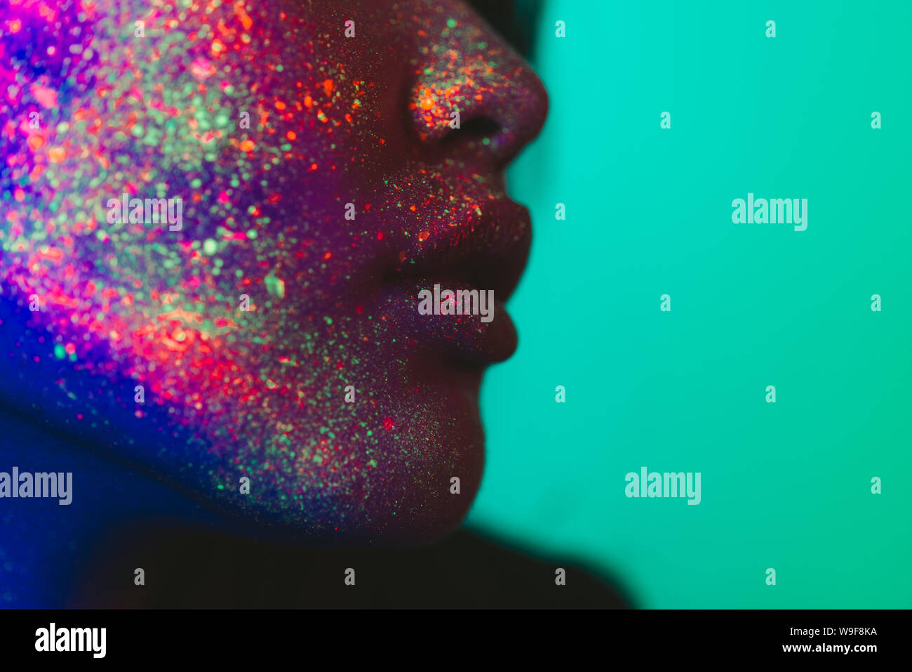 Beautiful young woman dancing and making party with fluorescent ...