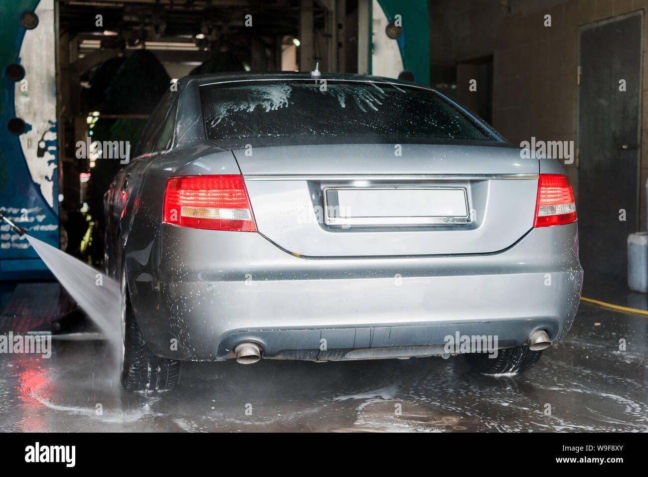 portable washer with pressure of water on grey automobile Stock Photo ...