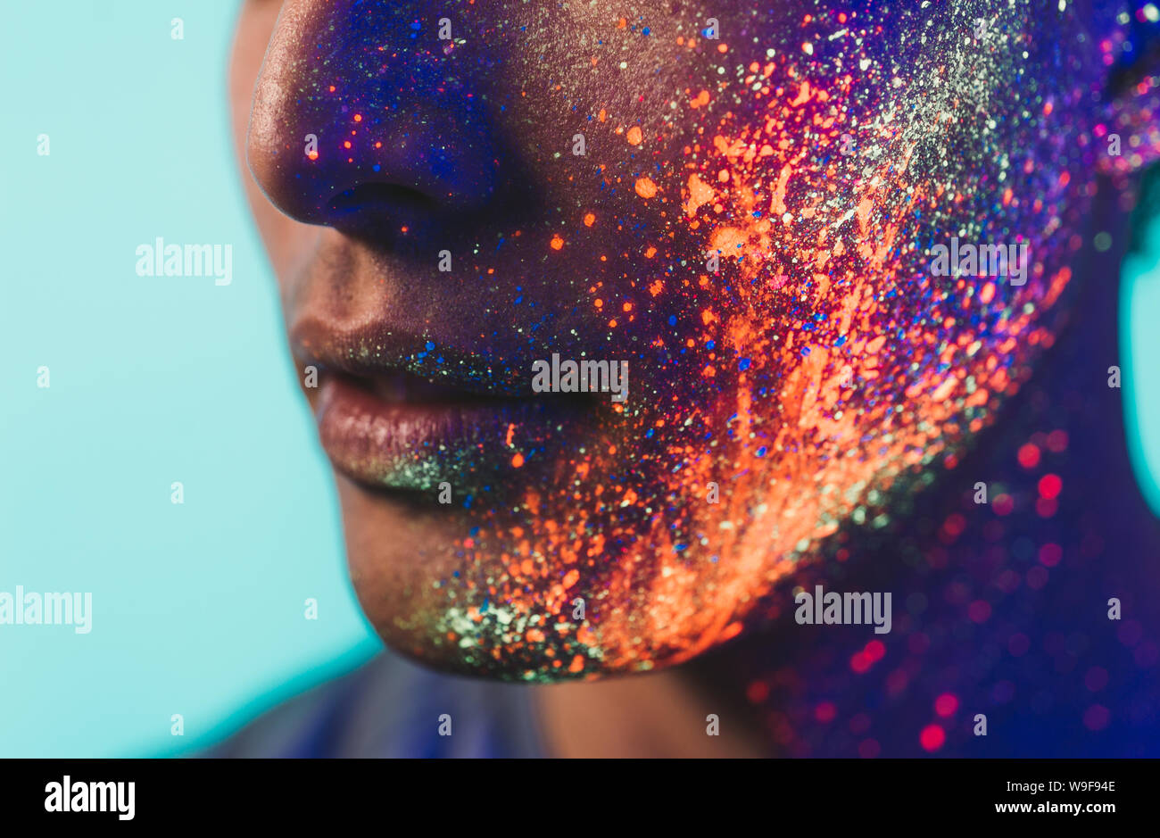 Handsome boy dancing at the rave party with fluorescent paintings on ...