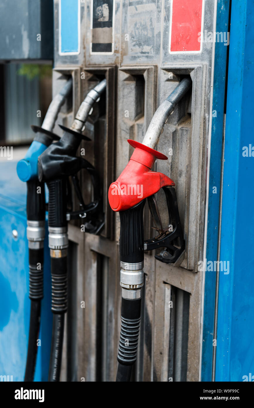 selective focus of red and blue gas pumps with fuel on gas station ...
